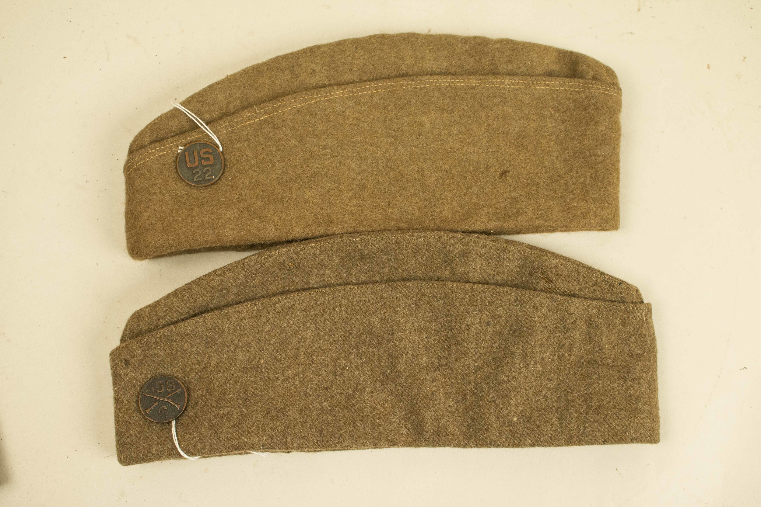 2 US WWI Painted Helmets and 4 Overseas Caps | Witherell's Auction House